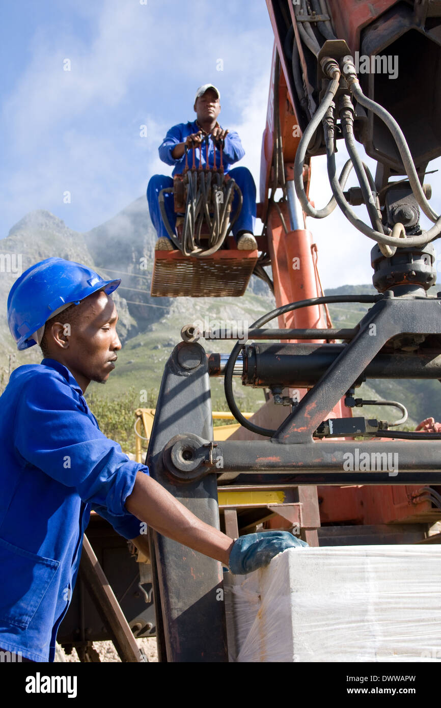 Alec Windvogel is a crane operator offloading bricks at a low cost ...