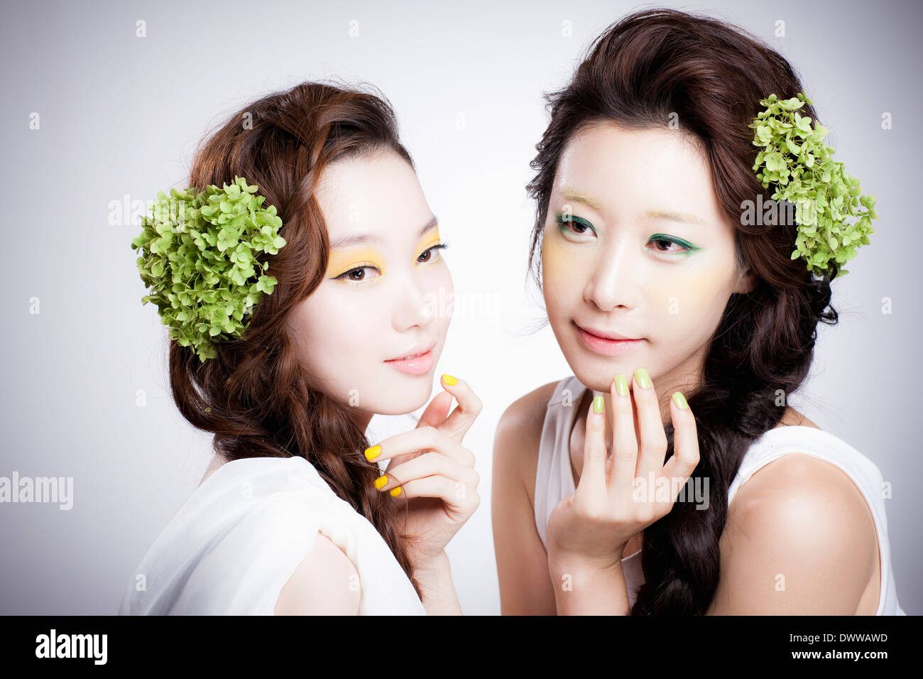 two women with heavy make up and a green decoration in the hair Stock ...