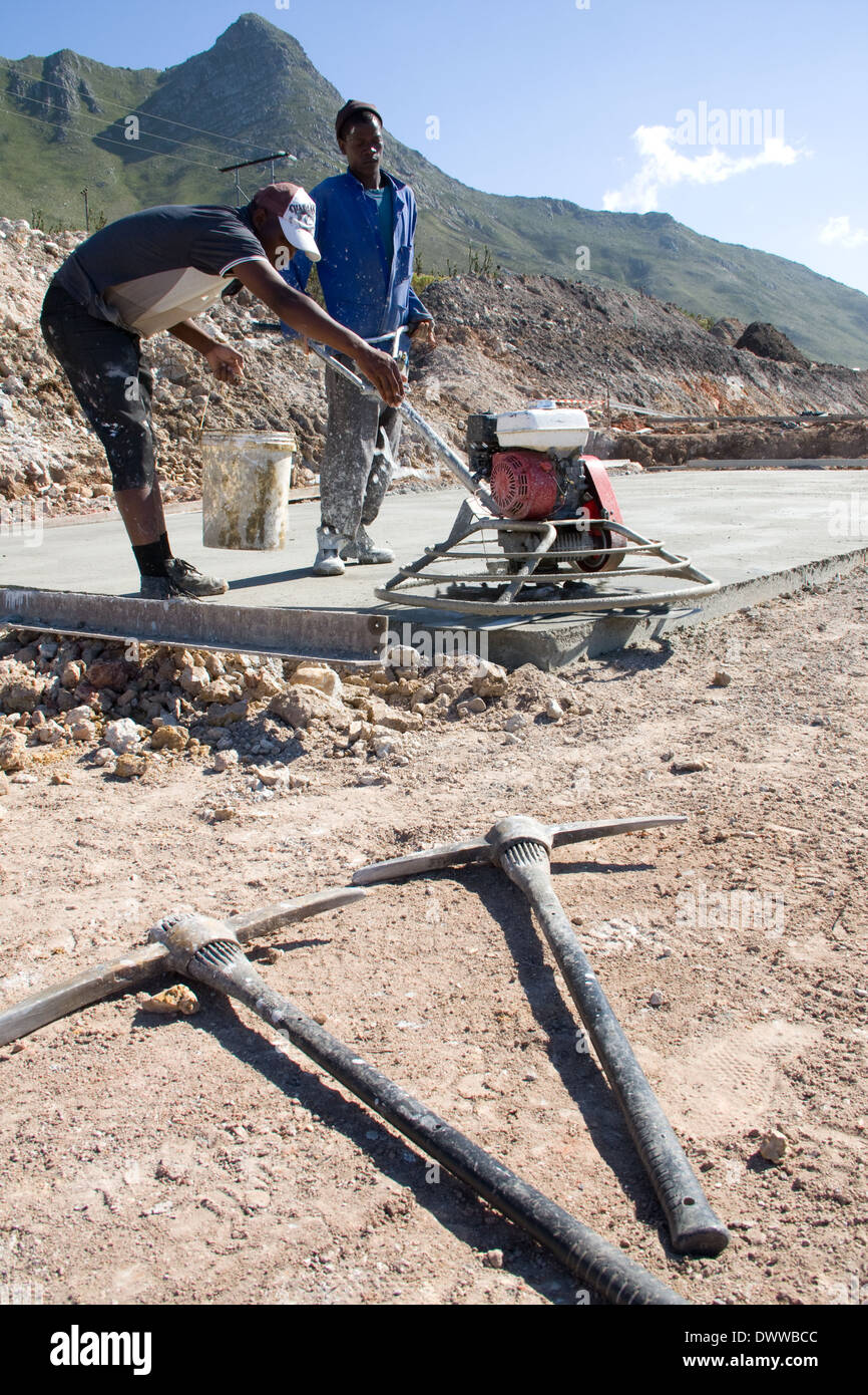 A powerfloat machine is used to smooth wet cement. Here is Msondezi ...