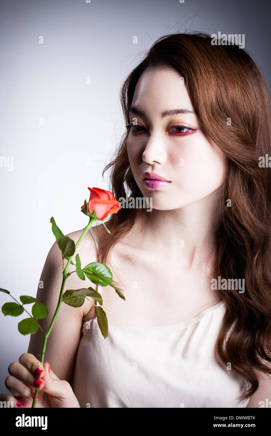 Woman with red rose hi-res stock photography and images - Alamy