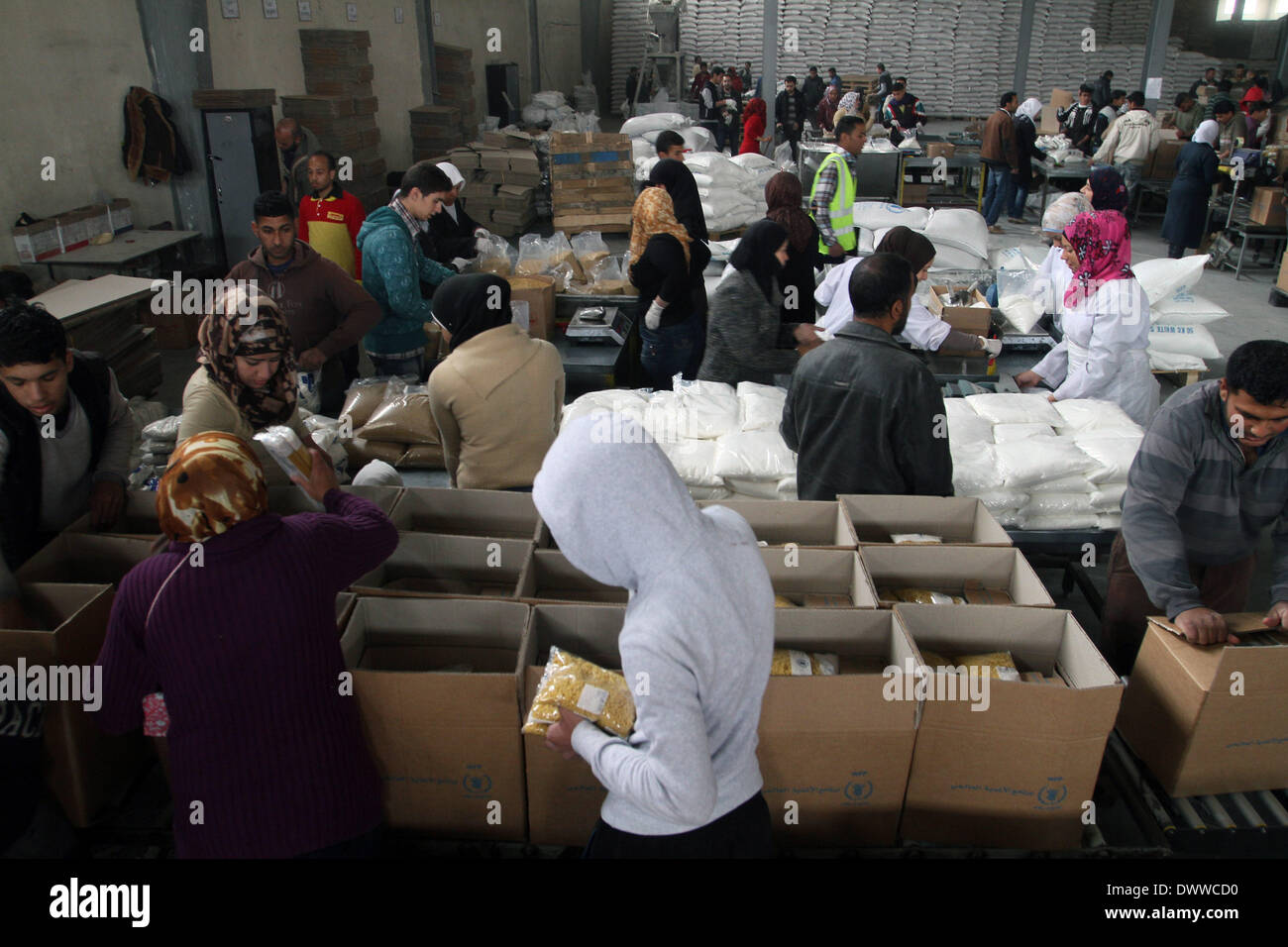 Damascus, Syria. 13th Mar, 2014. Workers at a warehouse of the UN's ...