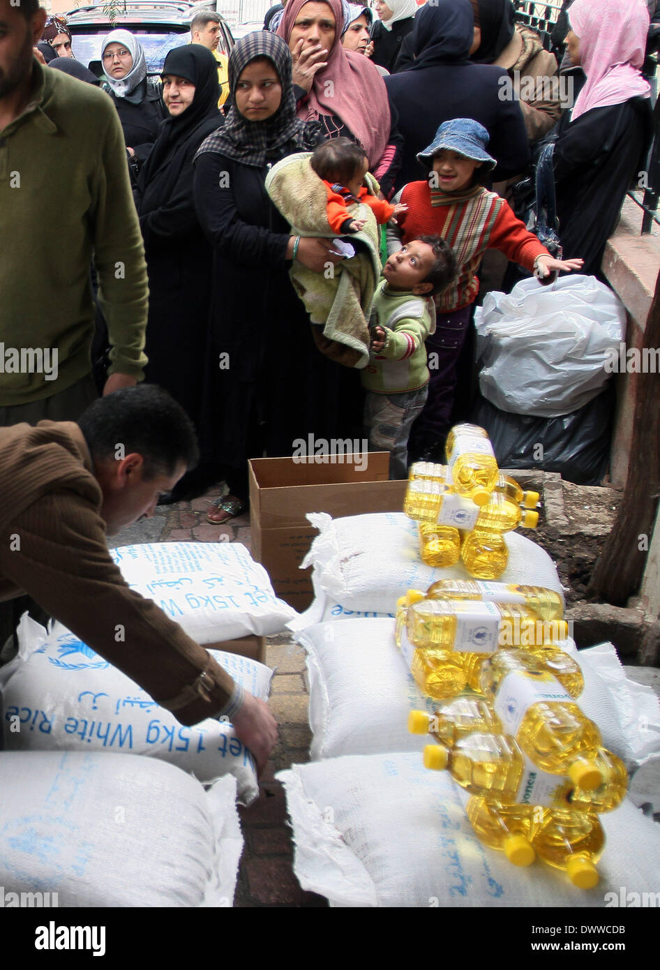Damascus, Syria. 13th Mar, 2014. Displaced Syrians receive food rations ...