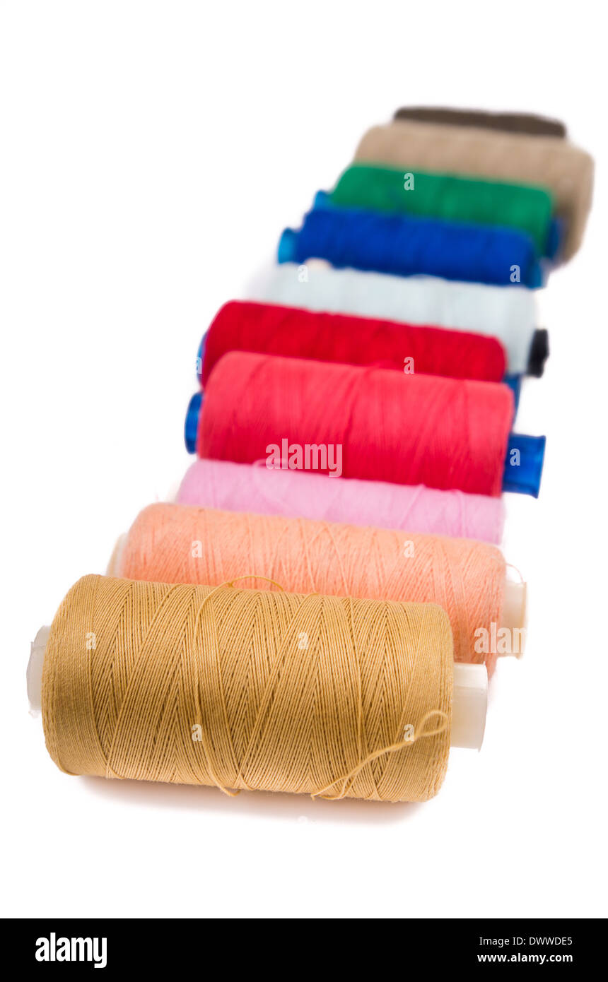 Pile of coloured bobbins of thread Stock Photo - Alamy
