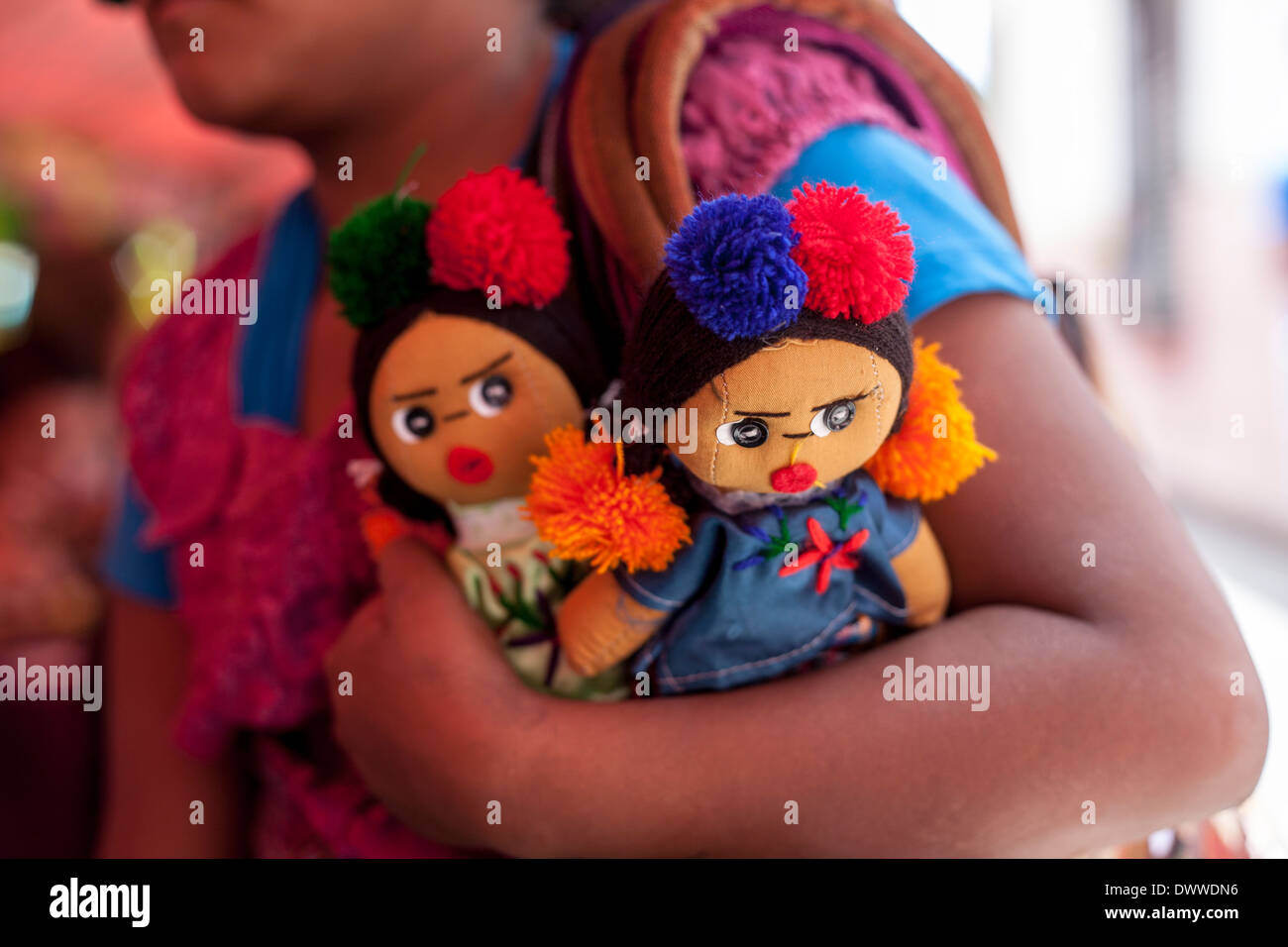 A Guatamalan girl sells traditional rag dolls at the weekend food feria ...
