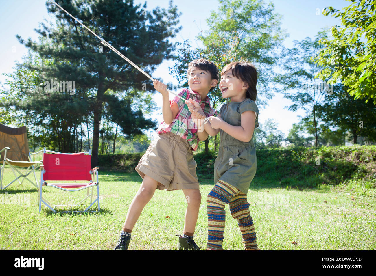 kids building a camping tent Stock Photo - Alamy