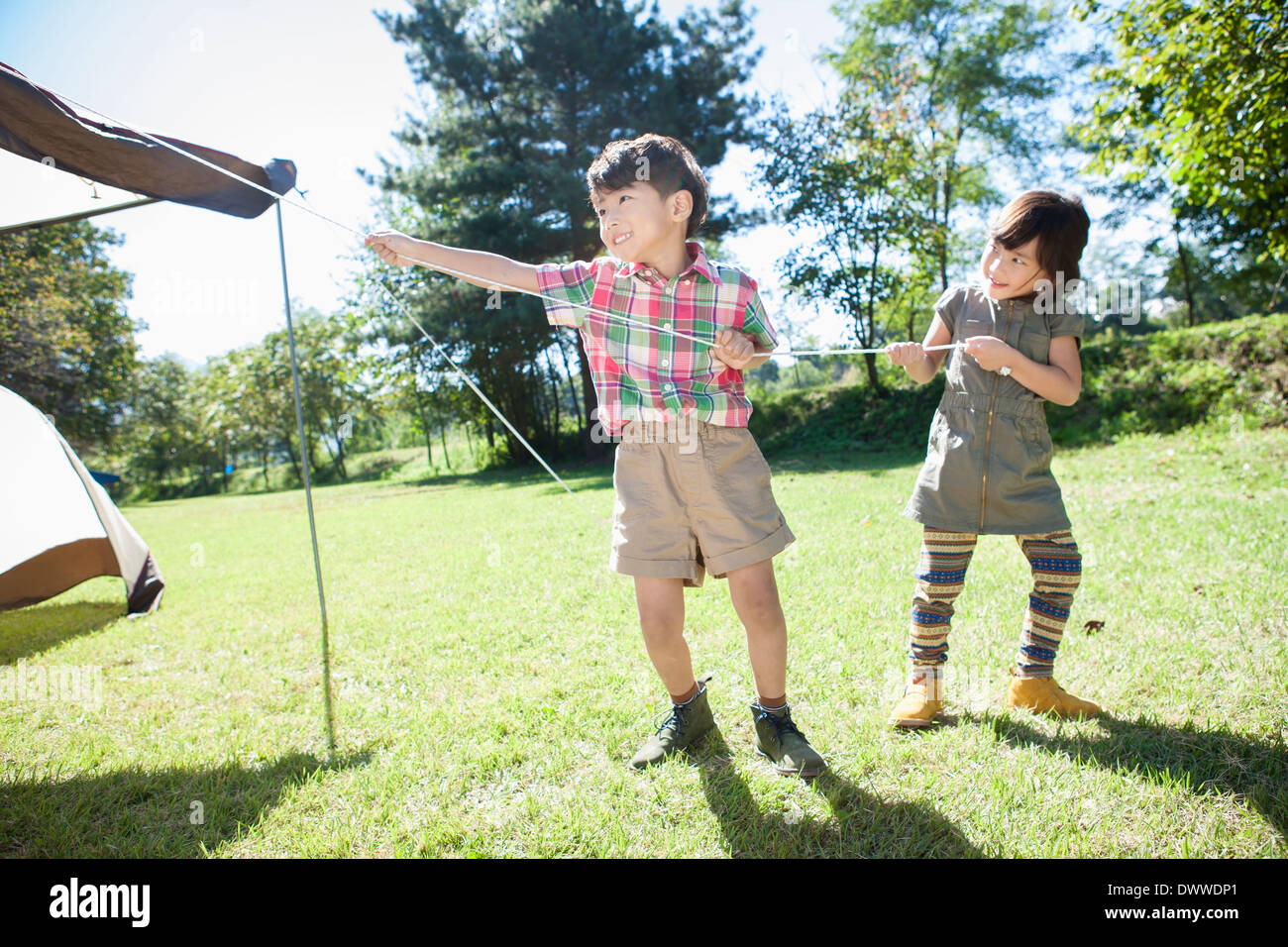 kids building a camping tent Stock Photo - Alamy