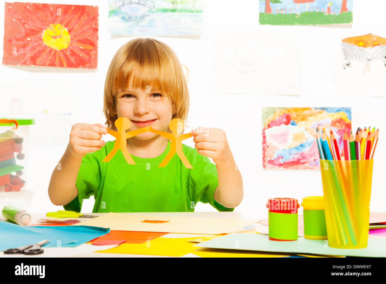 Happy 4 years old boy with paper garland on preschool art lesson Stock ...
