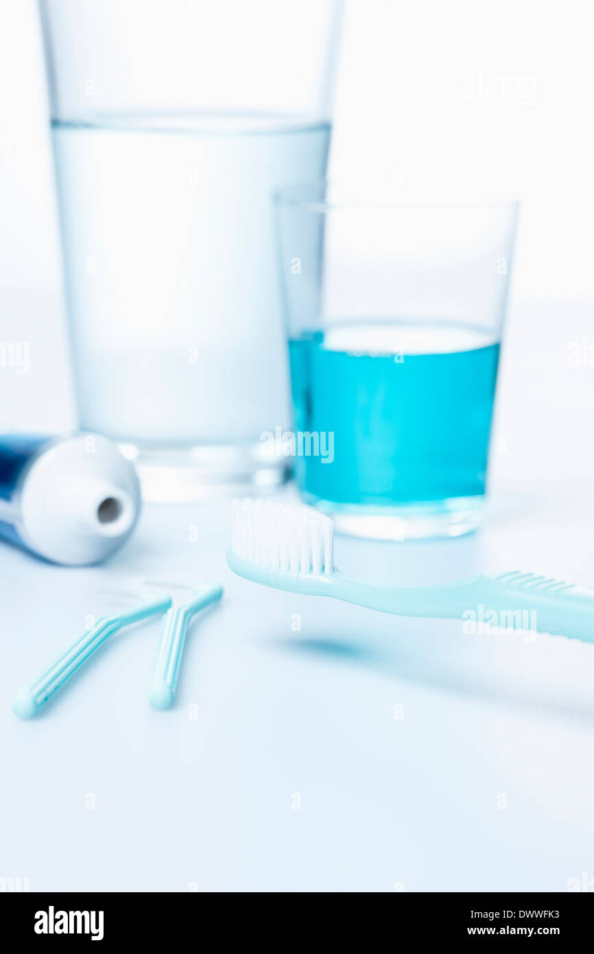 a toothbrush next to glasses with liquid Stock Photo - Alamy