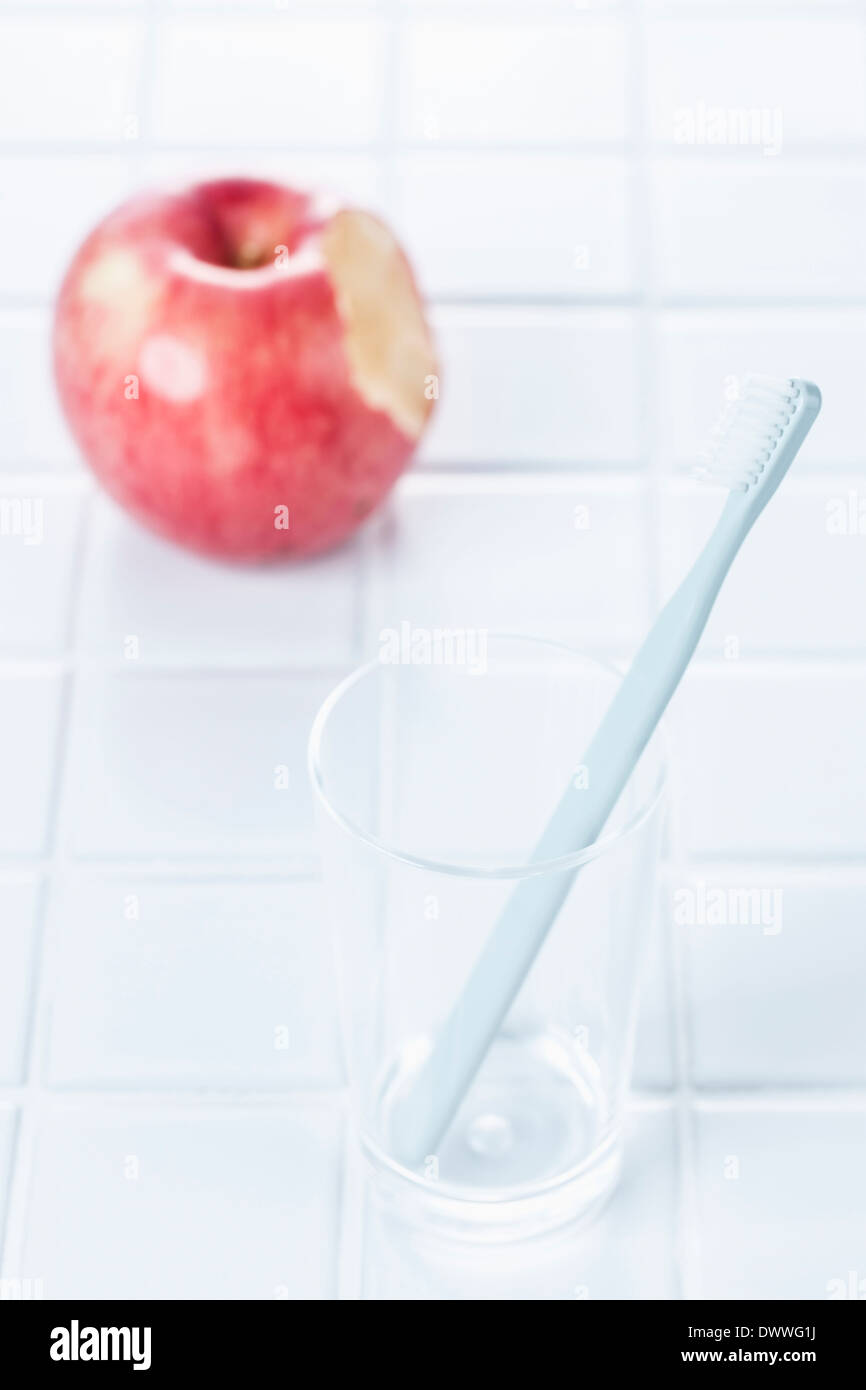 a toothbrush next to an apple Stock Photo - Alamy