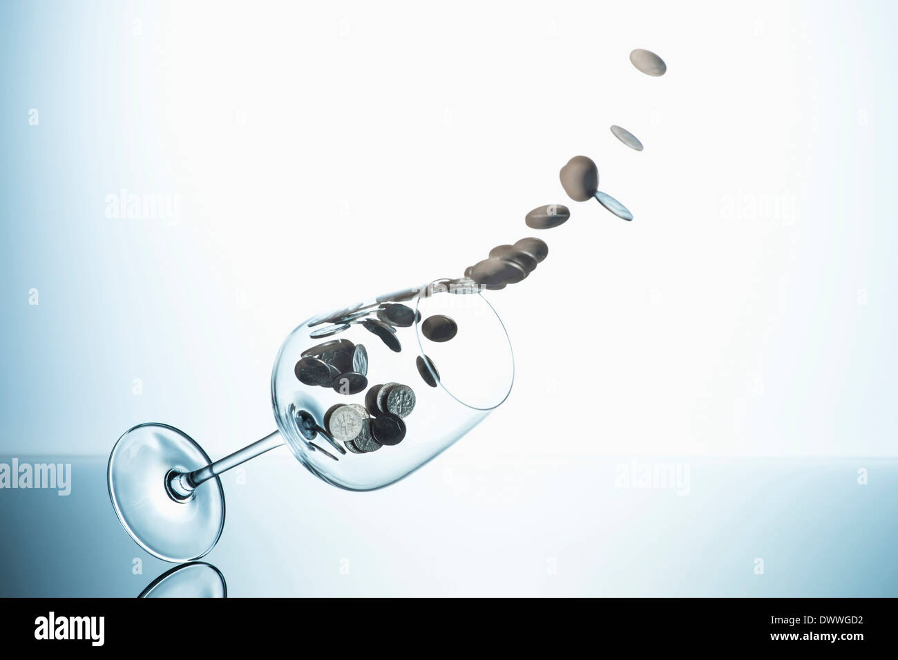 a wine glass with coins Stock Photo - Alamy