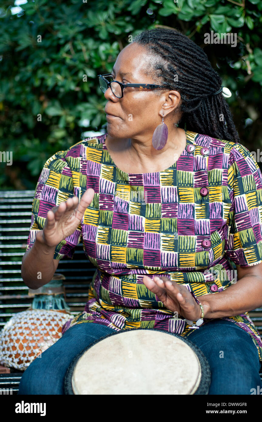 lady playing traditional african rhytms on djembe percussions Stock ...