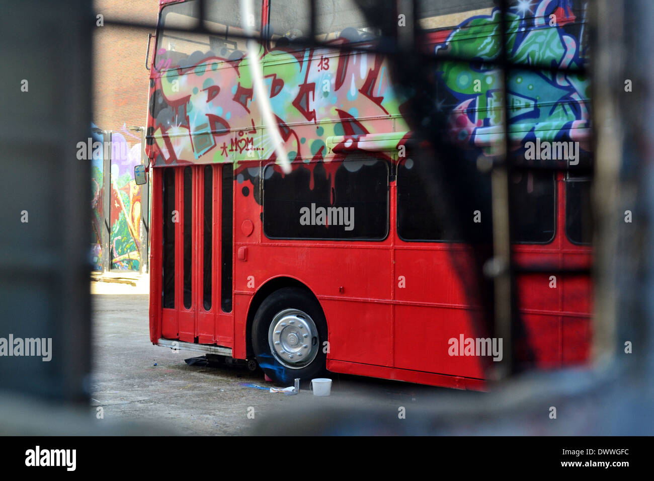 Red London bus with graffiti in Shoreditch, London Stock Photo - Alamy