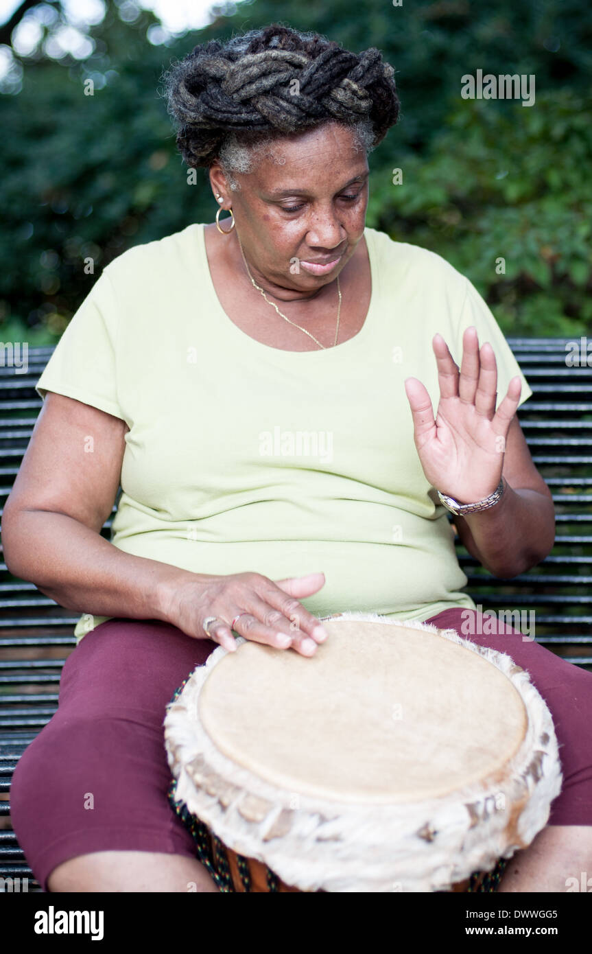 lady playing traditional african rhytms on djembe percussions Stock ...