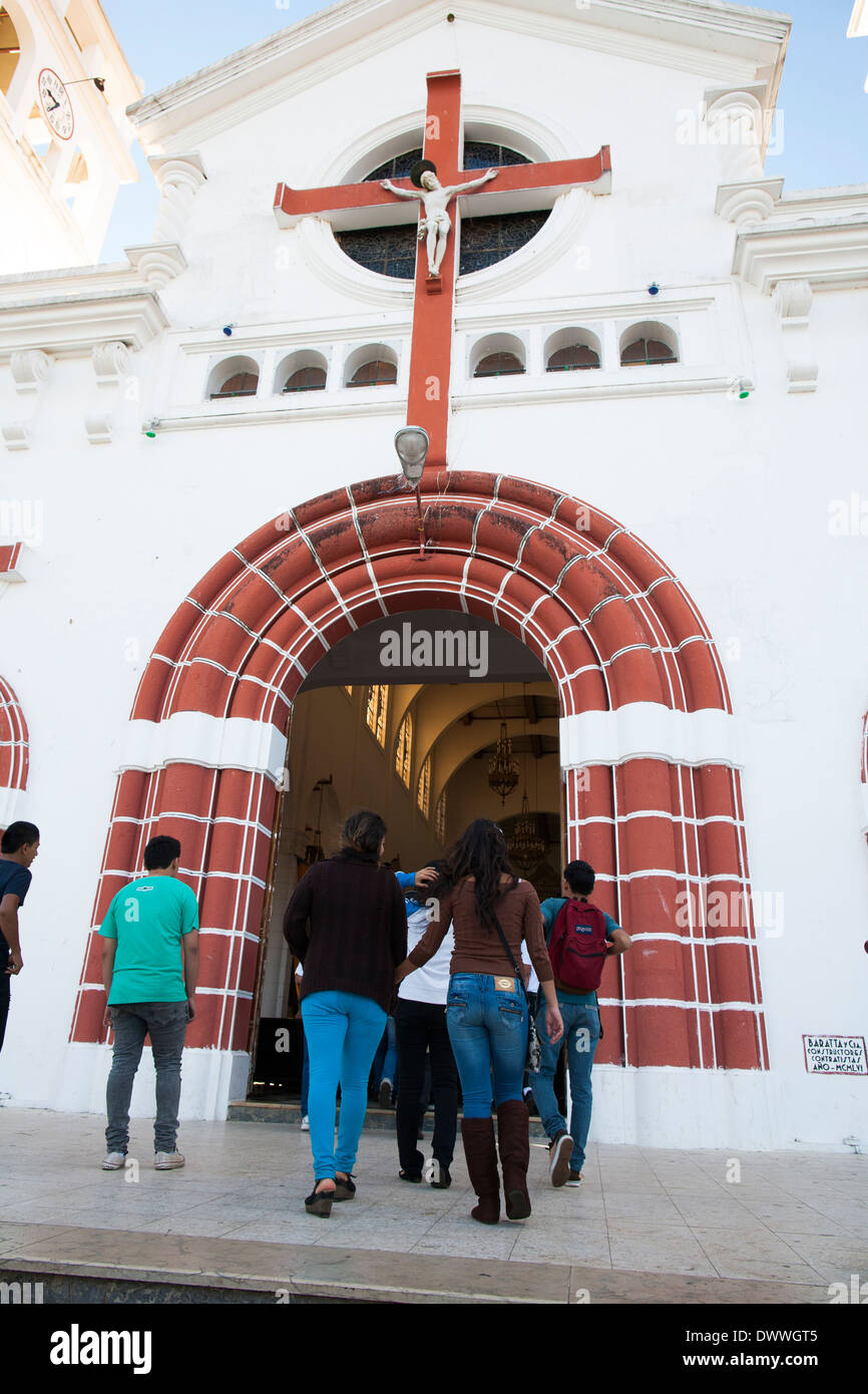 A crowd of people walk into the church of the black christ in Juayua on ...