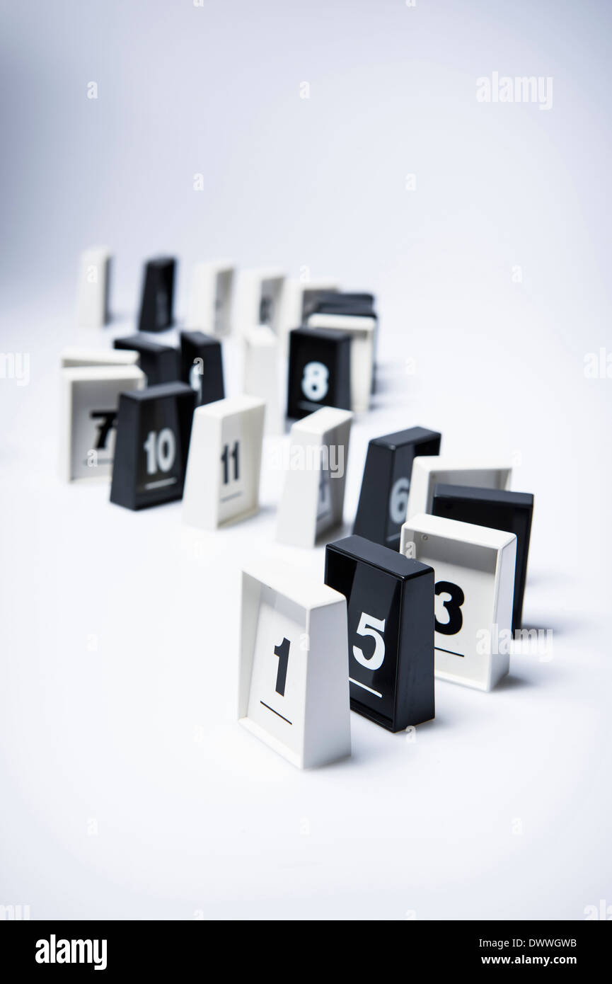 domino pieces with numbers standing in a line Stock Photo - Alamy