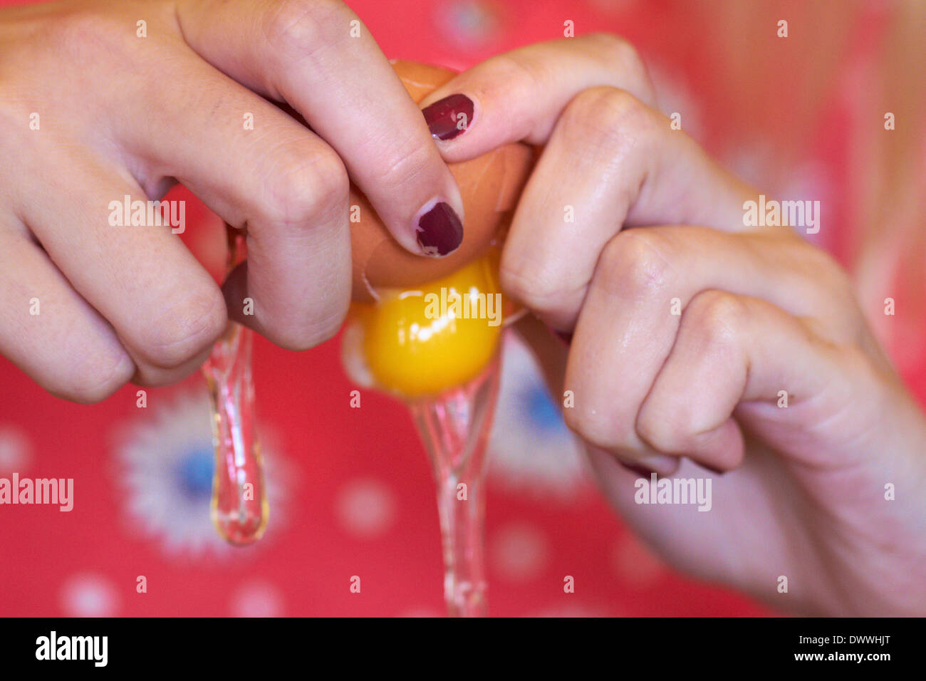 woman cracking open egg Stock Photo - Alamy