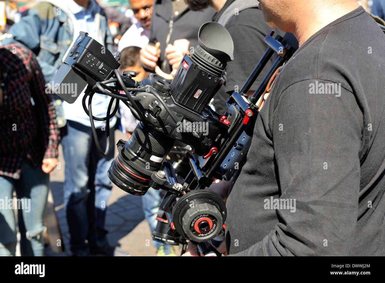 Red digital cinema camera with shoulder rig being used in Place Jema el ...