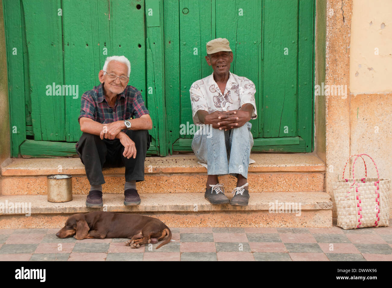 Two old Cuban men with a dog sitting on doorstep, Trinidad, Cuba Stock ...