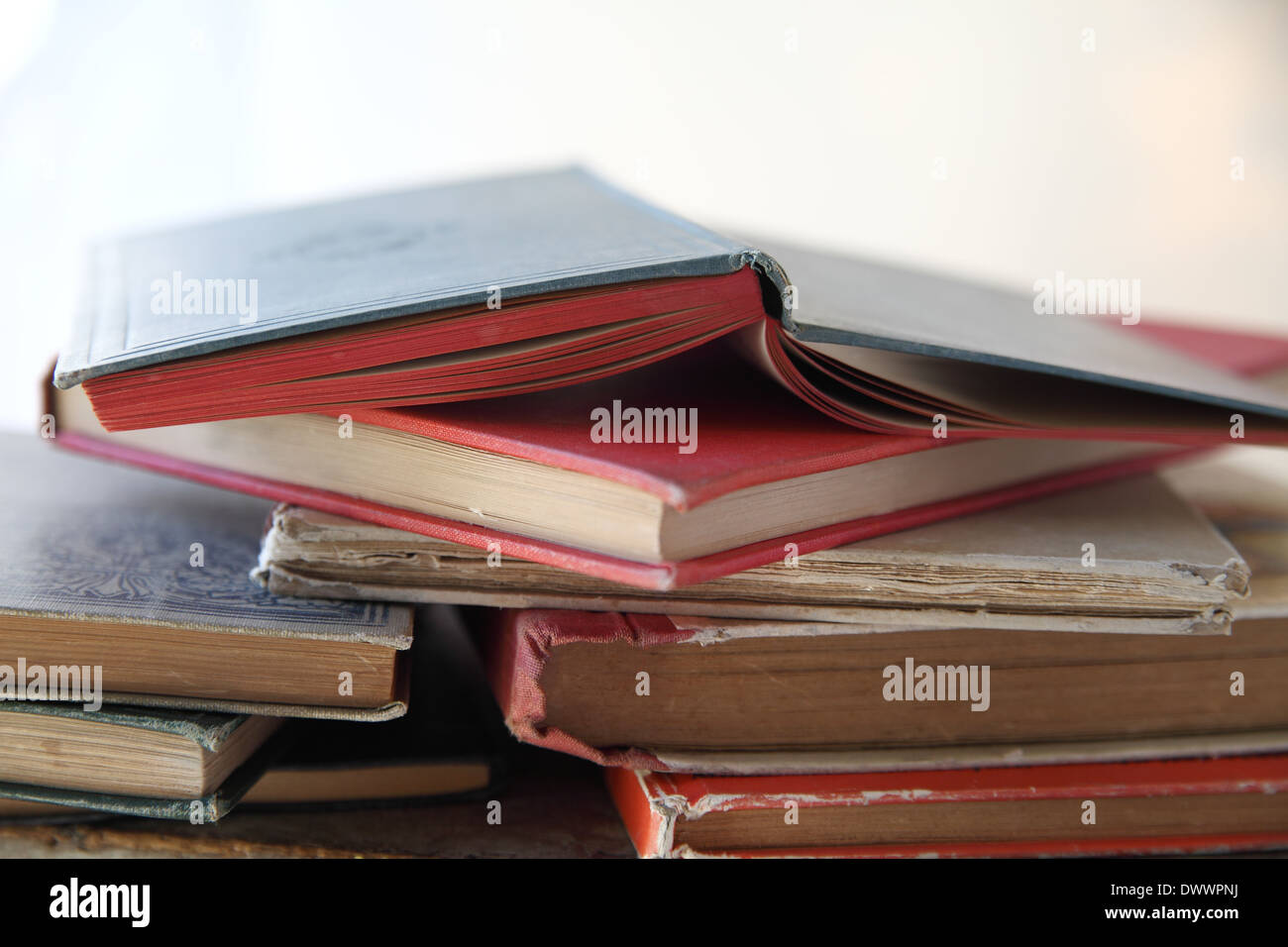 stacks of used books, top one turned over Stock Photo - Alamy