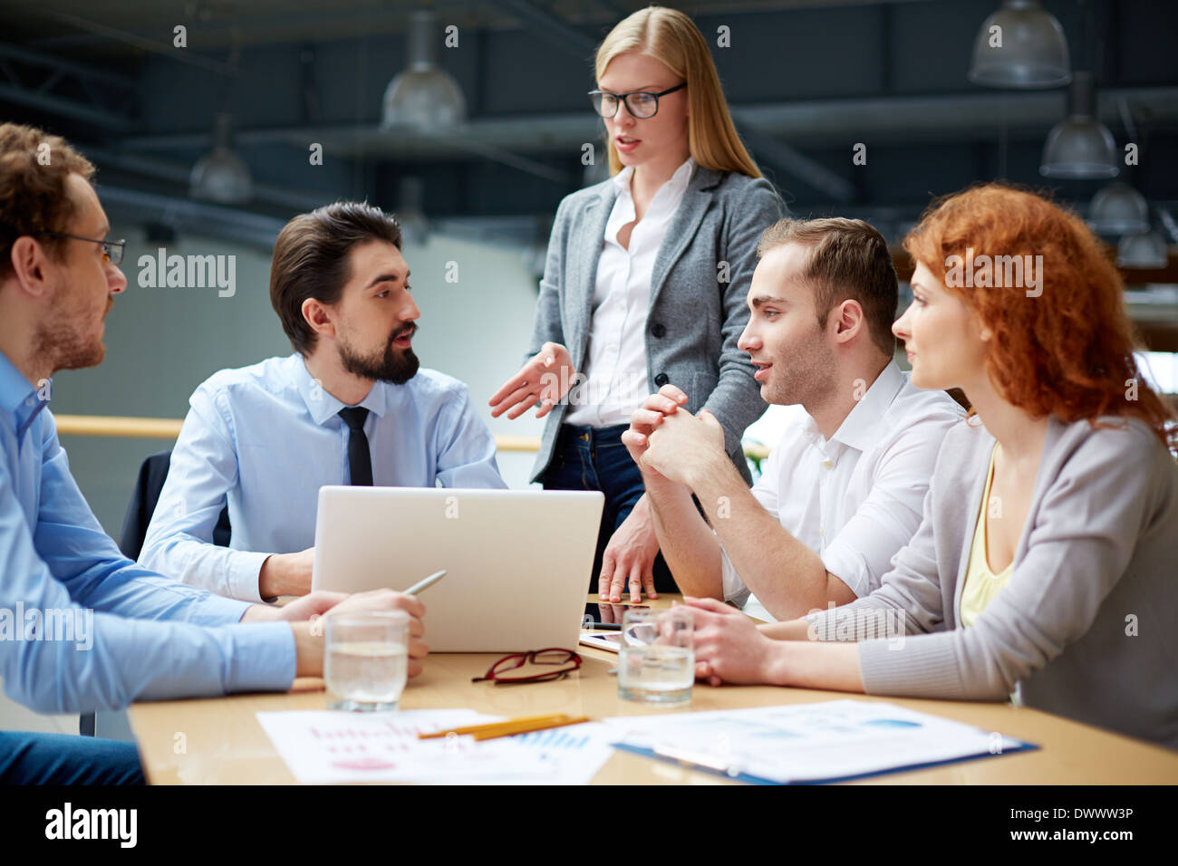 Group of business partners sharing ideas upon project at meeting Stock ...