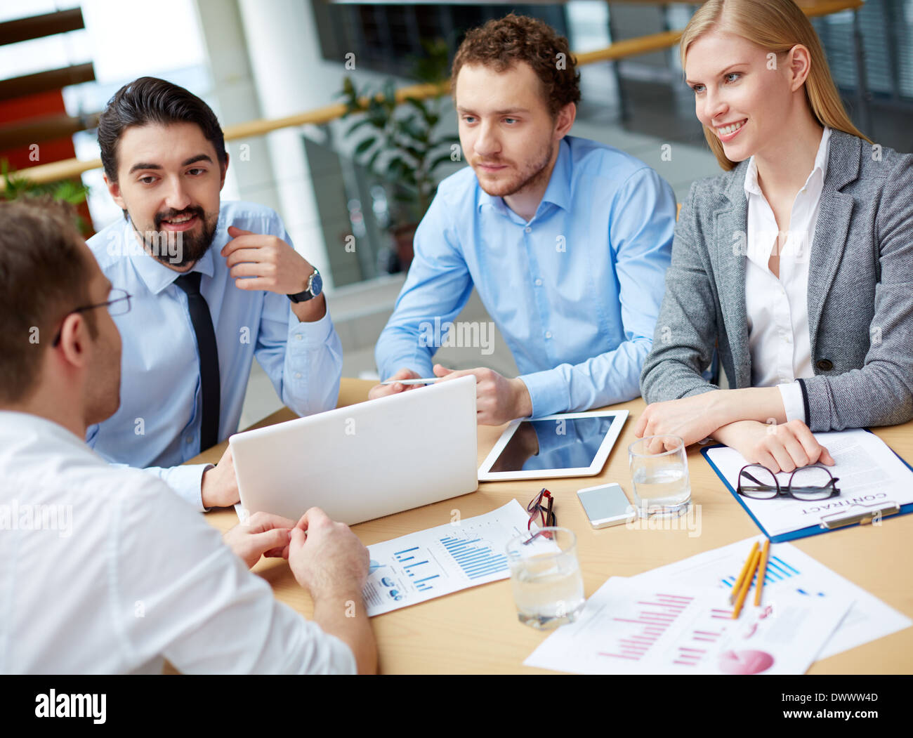 Group of business partners interviewing young man at meeting Stock ...