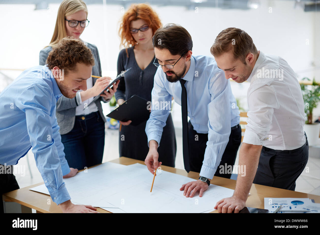 Team engineers discussing blueprint construction hi-res stock ...