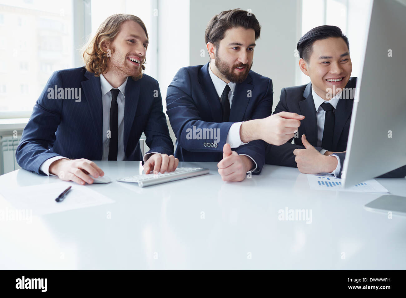 Three businessman discussing project in meeting room Stock Photo - Alamy