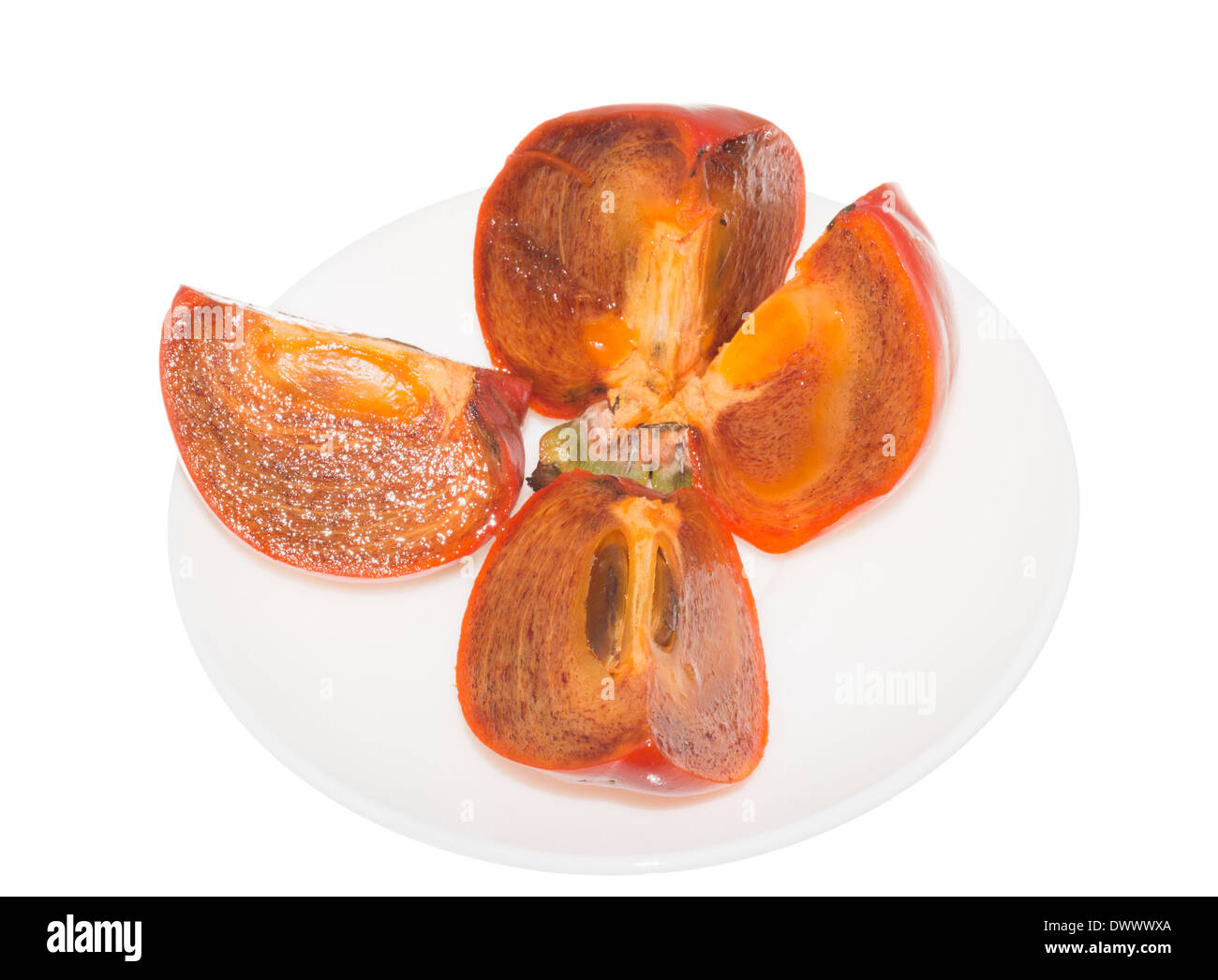 Cut persimmon on a plate is isolated on white background Stock Photo ...