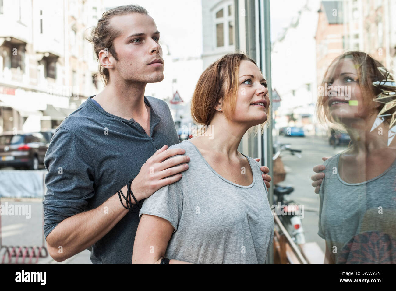 Man and woman looking at window display Stock Photo - Alamy