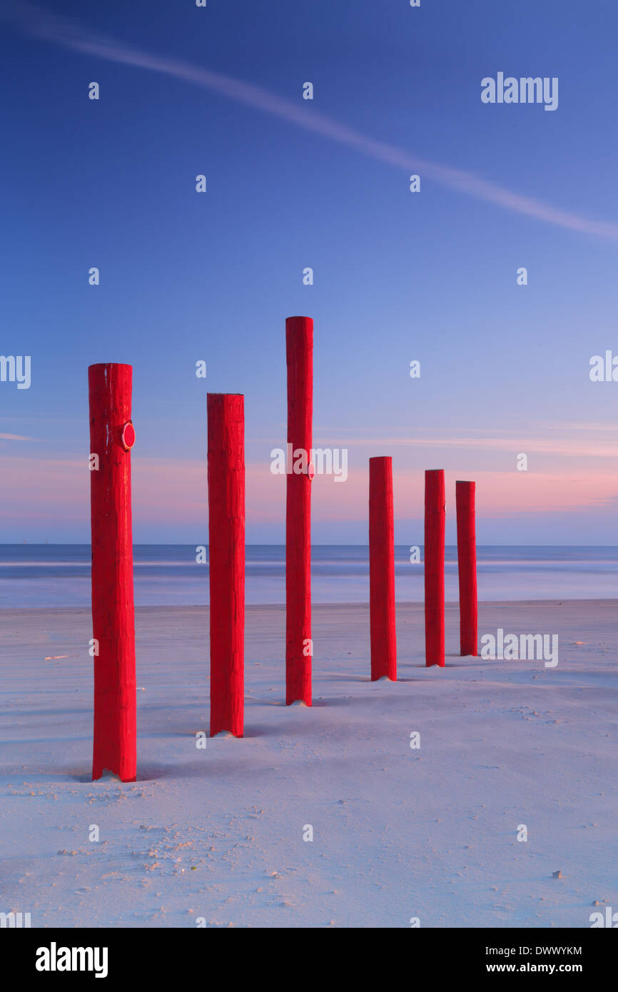 Red posts illuminated at dusk on Galveston Beach, Texas, USA Stock ...