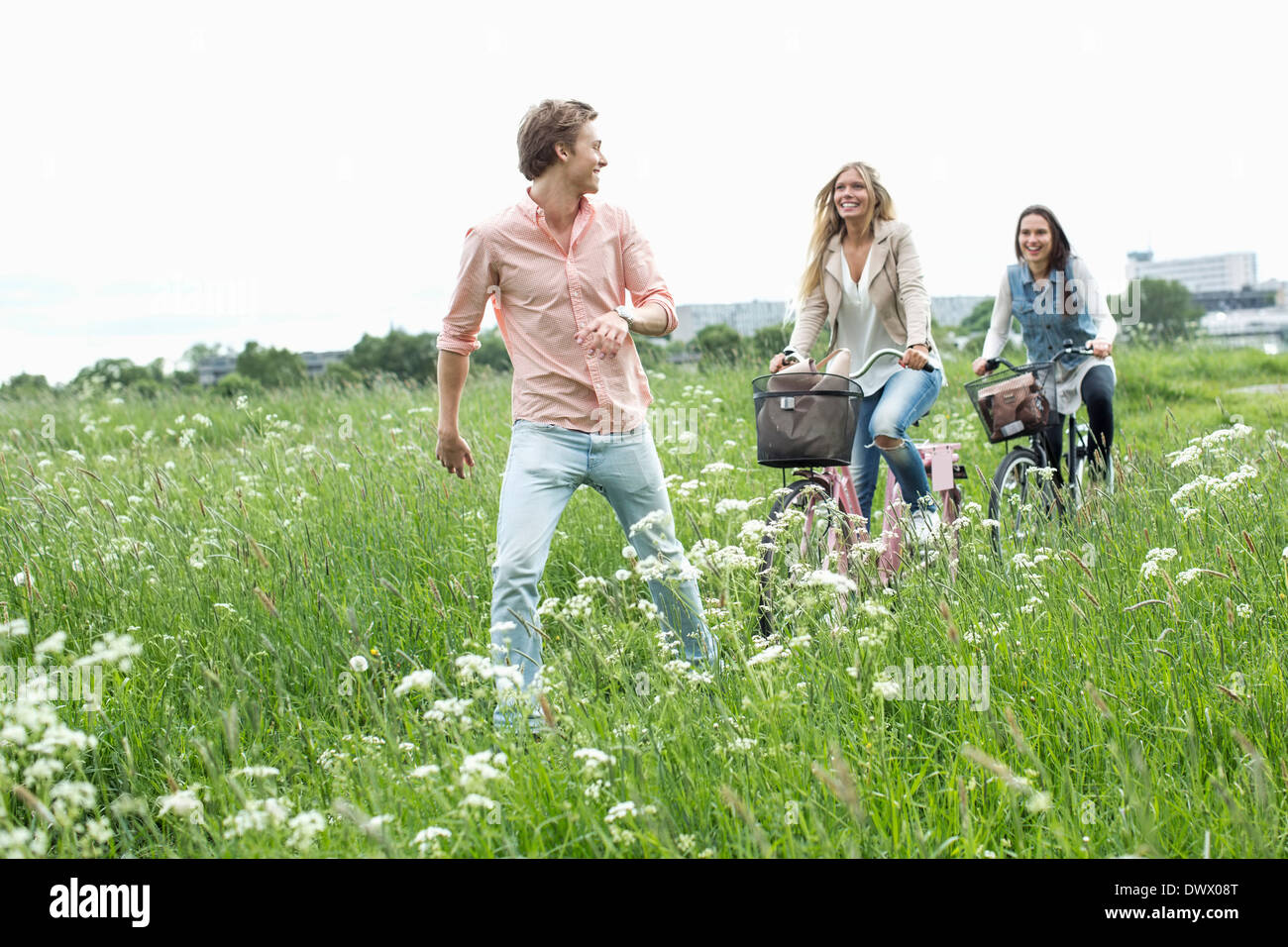 Young friends riding bike hi-res stock photography and images - Alamy