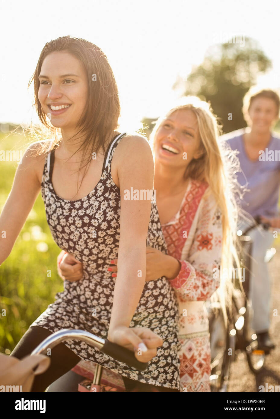 Happy friends enjoying bicycle ride at countryside Stock Photo - Alamy