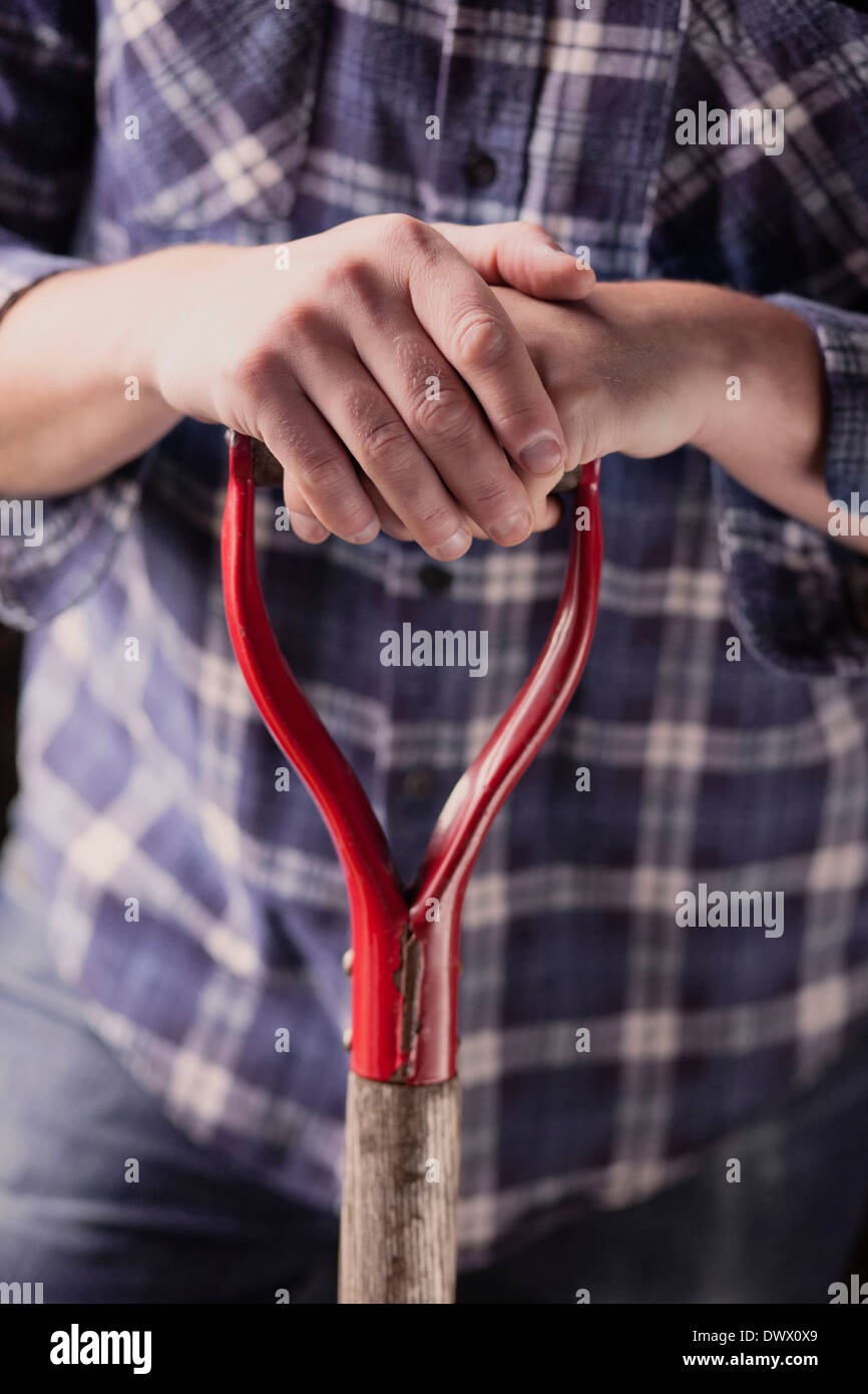 Midsection of farmer holding pitchfork's handle Stock Photo - Alamy