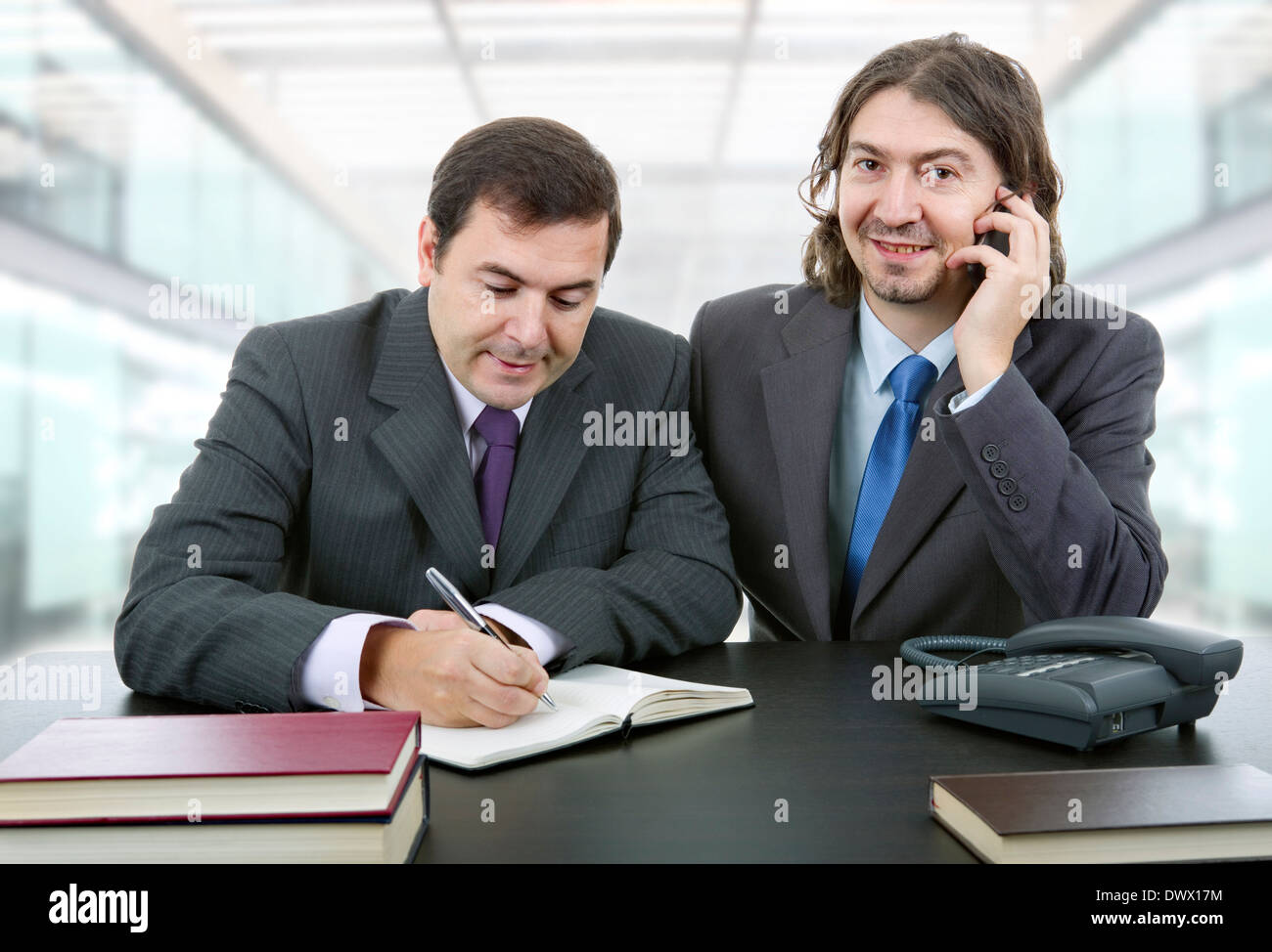 business team working at a desk at the office Stock Photo - Alamy