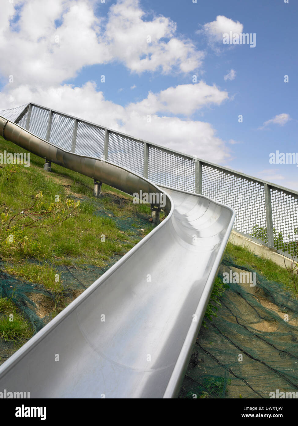 Childrens' silver slide in park Stock Photo - Alamy