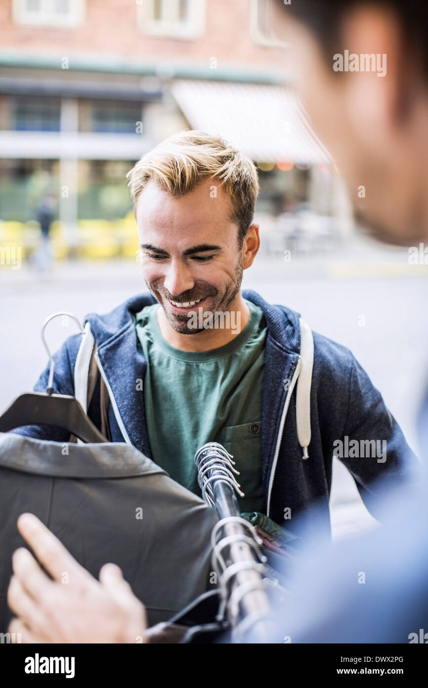 Happy man shopping at clothing store Stock Photo - Alamy