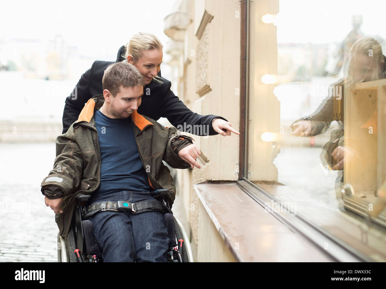 Disabled man on wheelchair widow shopping with caretaker Stock Photo ...