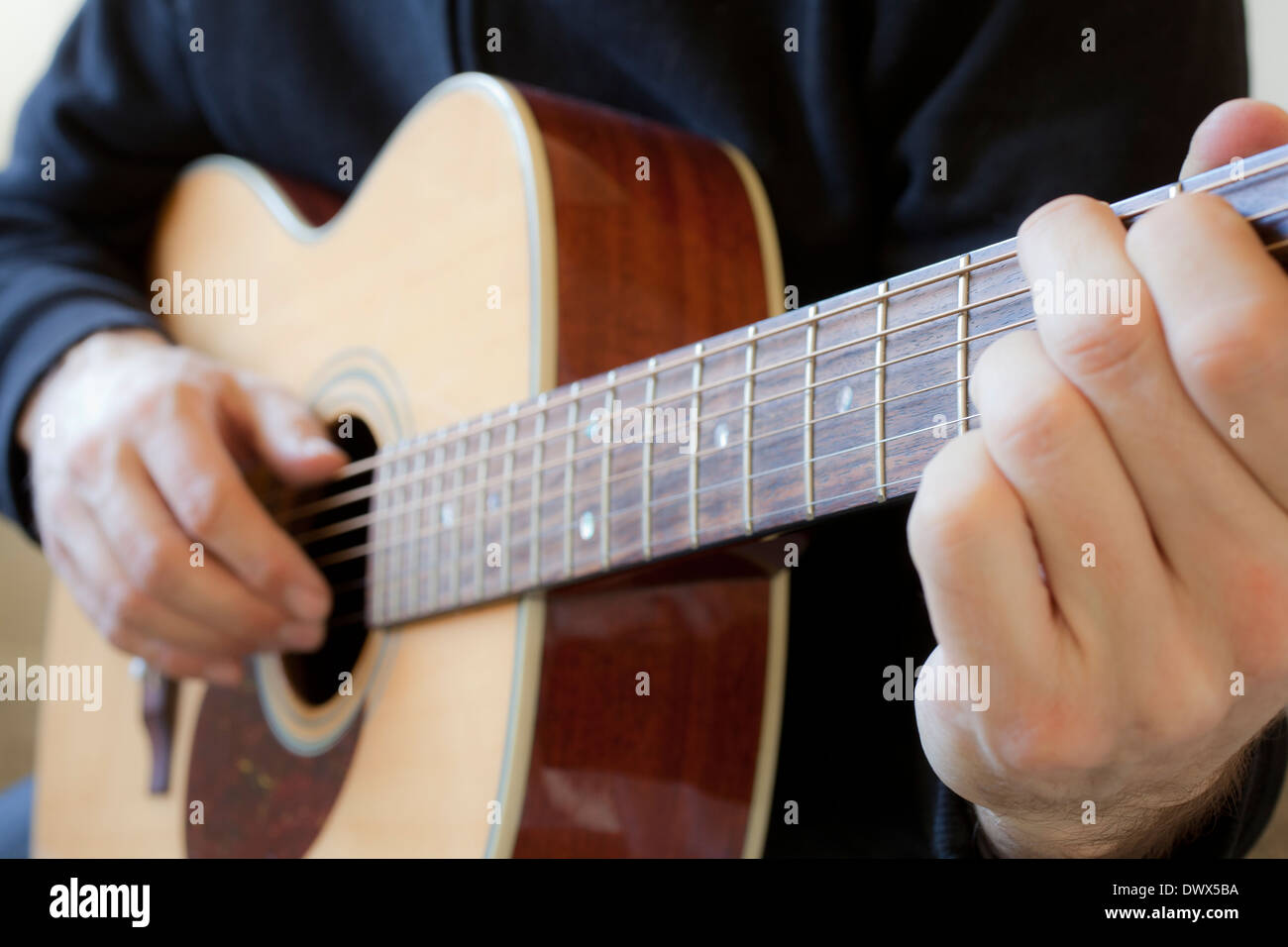 Person playing an acoustic guitar Stock Photo - Alamy