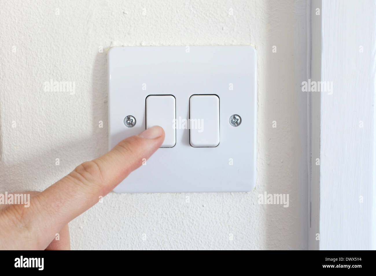 Finger pusing light switch Stock Photo - Alamy