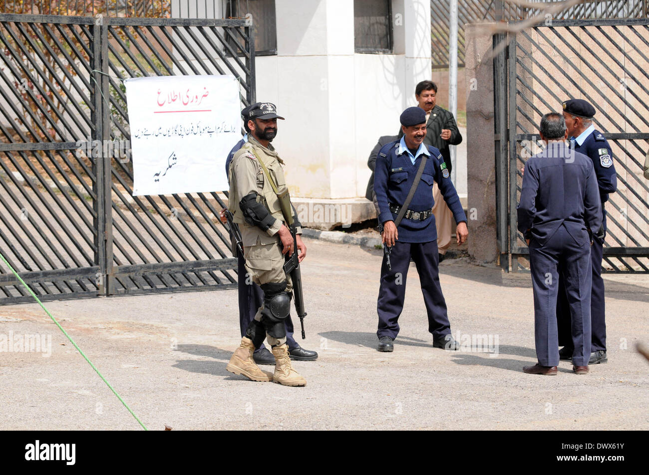 Islamabad, Pakistan. 14th Mar, 2014. Pakistani security officials stand ...