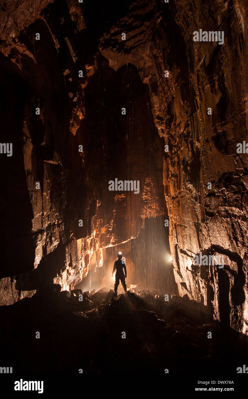 A female caver in Northern Lights passage in Ogof Ffynnon Ddu, Brecon ...