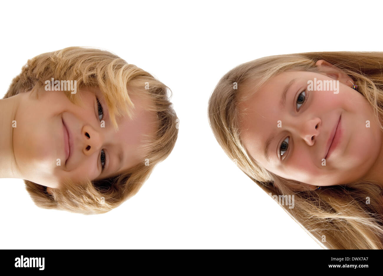 two young girls looking down and smile Stock Photo - Alamy