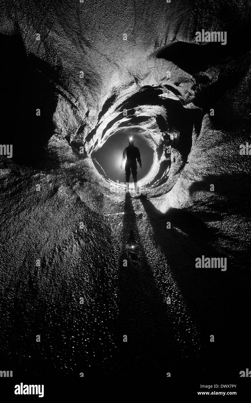 A female caver in silhouette in Bakerloo Straight, Dan-yr-Ogof Caves ...