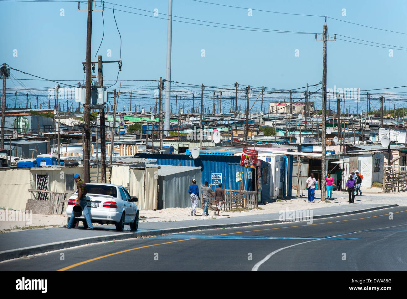 Road with makeshift houses and people in Khayelitsha, Cape Town ...
