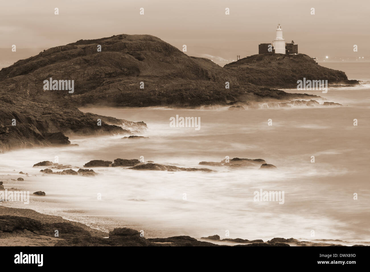 Mumbles Head and Lighthouse shrouded in spray sepia tone in Swansea Bay ...
