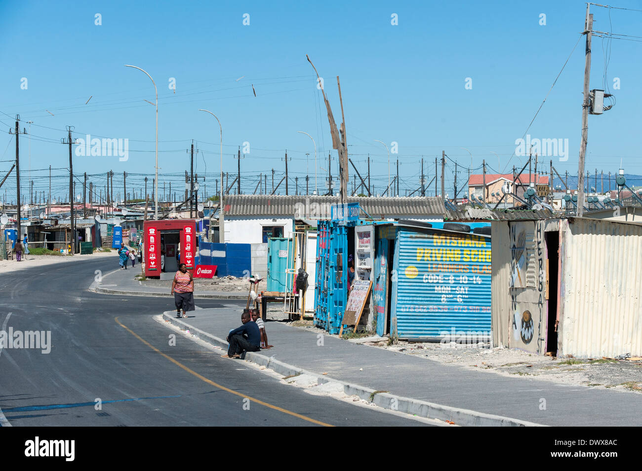 Road with makeshift houses and people in Khayelitsha, Cape Town ...