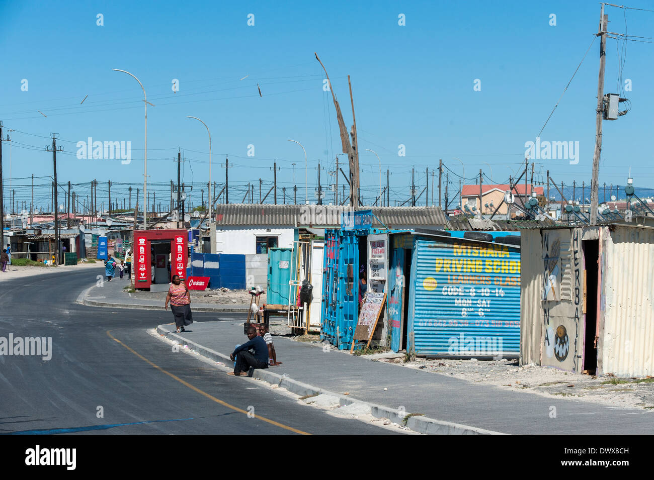 Road with makeshift houses and people in Khayelitsha, Cape Town ...