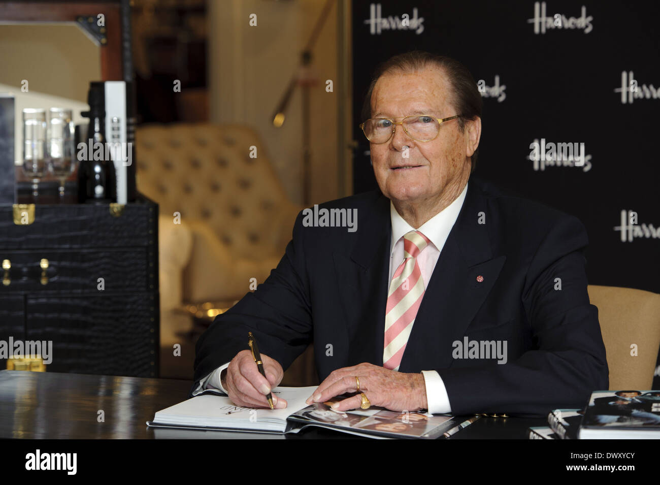 Sir Roger Moore signs copies of his new book 'Bond On Bond' at Harrods ...
