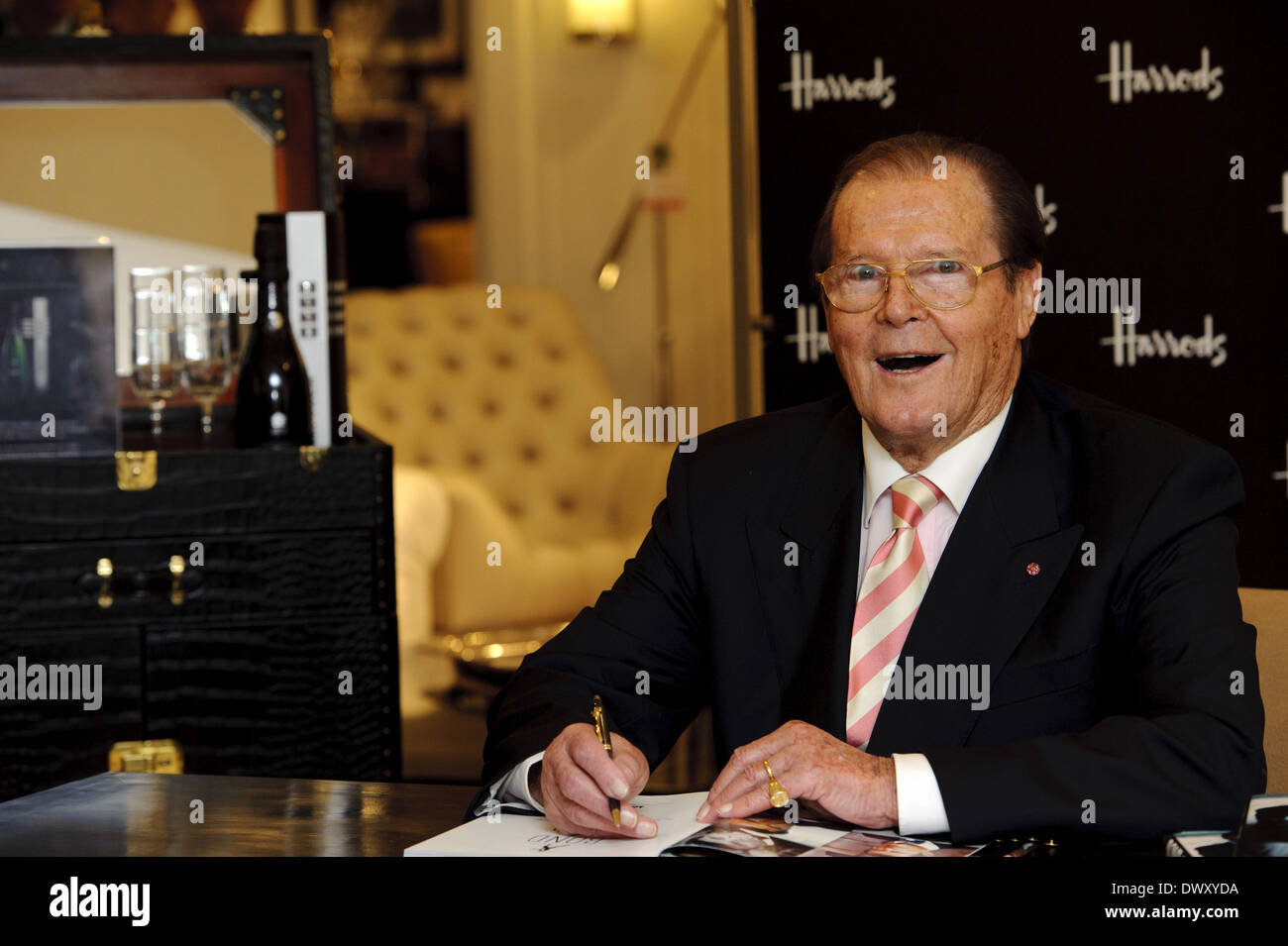 Sir Roger Moore signs copies of his new book 'Bond On Bond' at Harrods ...
