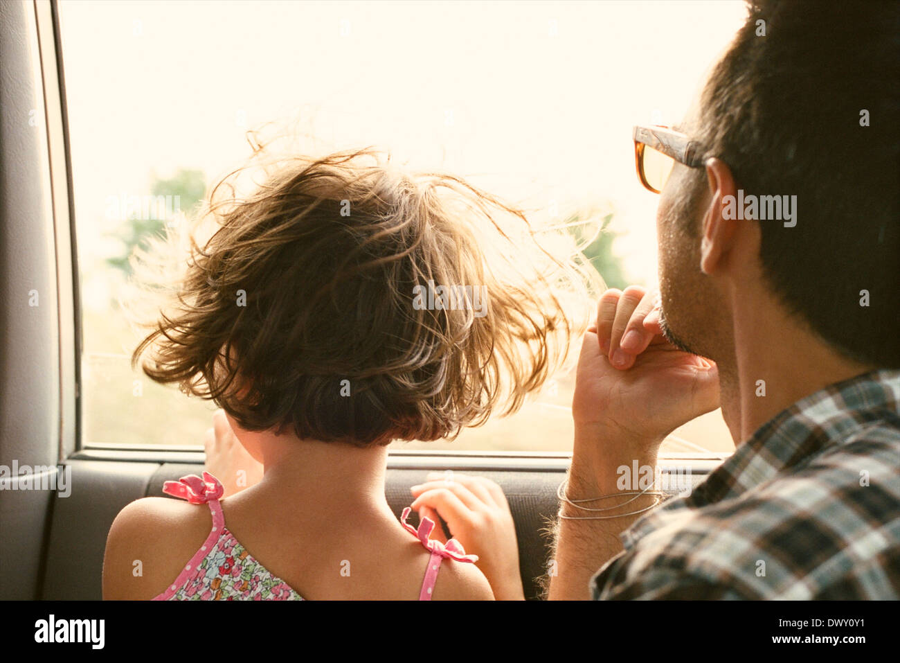 Father and daughter looking through car window Stock Photo - Alamy